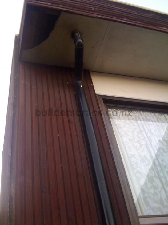 Broken hardiflex soffit lining by downpipe (#53322) | Builderscrack