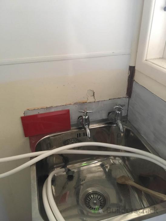 Wall tiling splashback around laundry tub. (# 500356) | Builderscrack